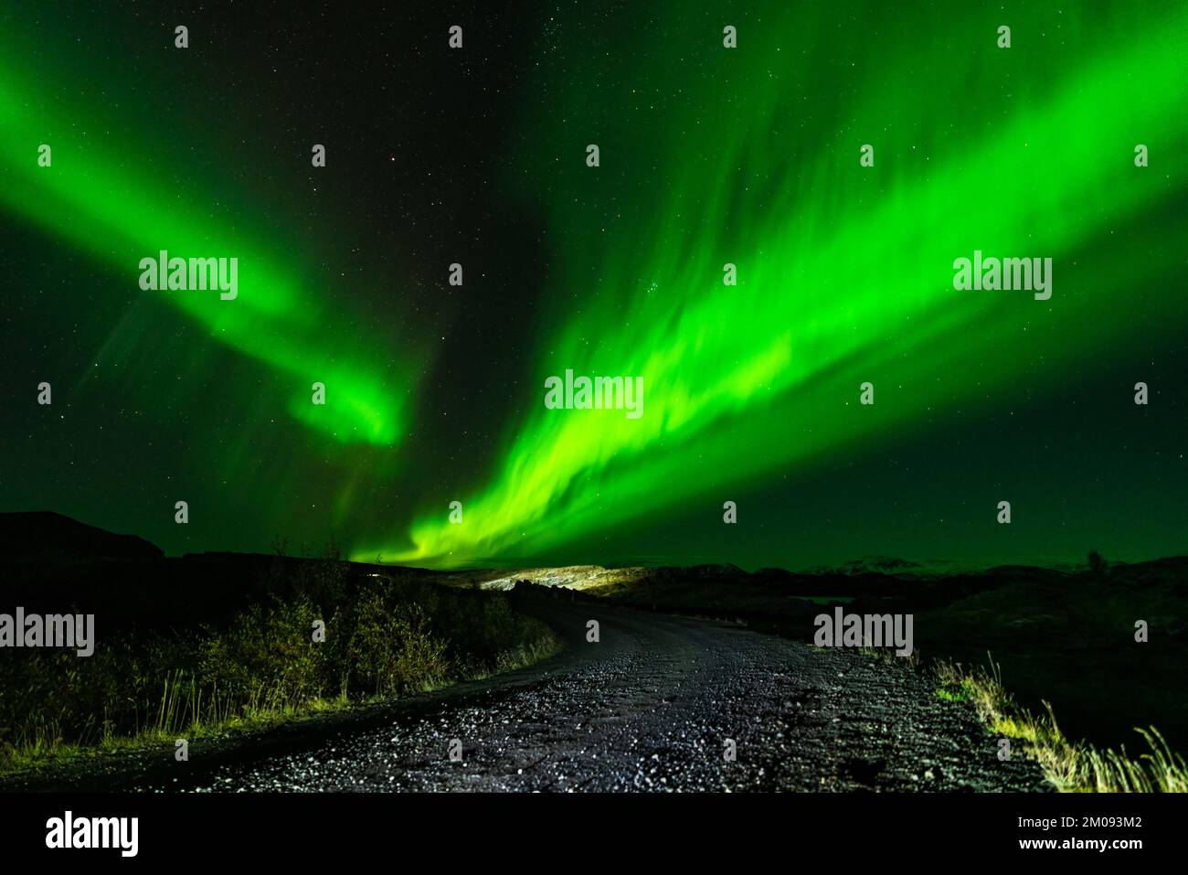 Aurora borealis green light beams over the track Stock Photo - Alamy