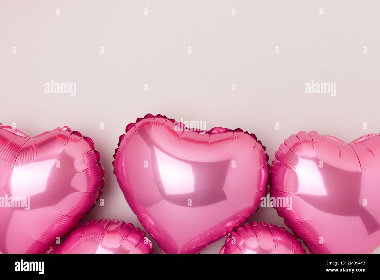 Frame made of pink inflatable foil balloons in a heart shape. Concept ...