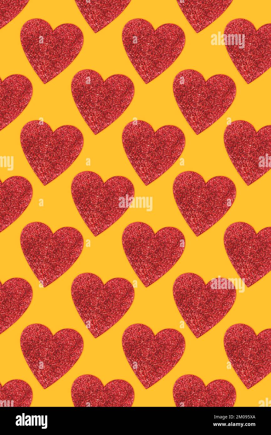 Repetitive pattern made of red glittering hearts. Creative layout on a ...