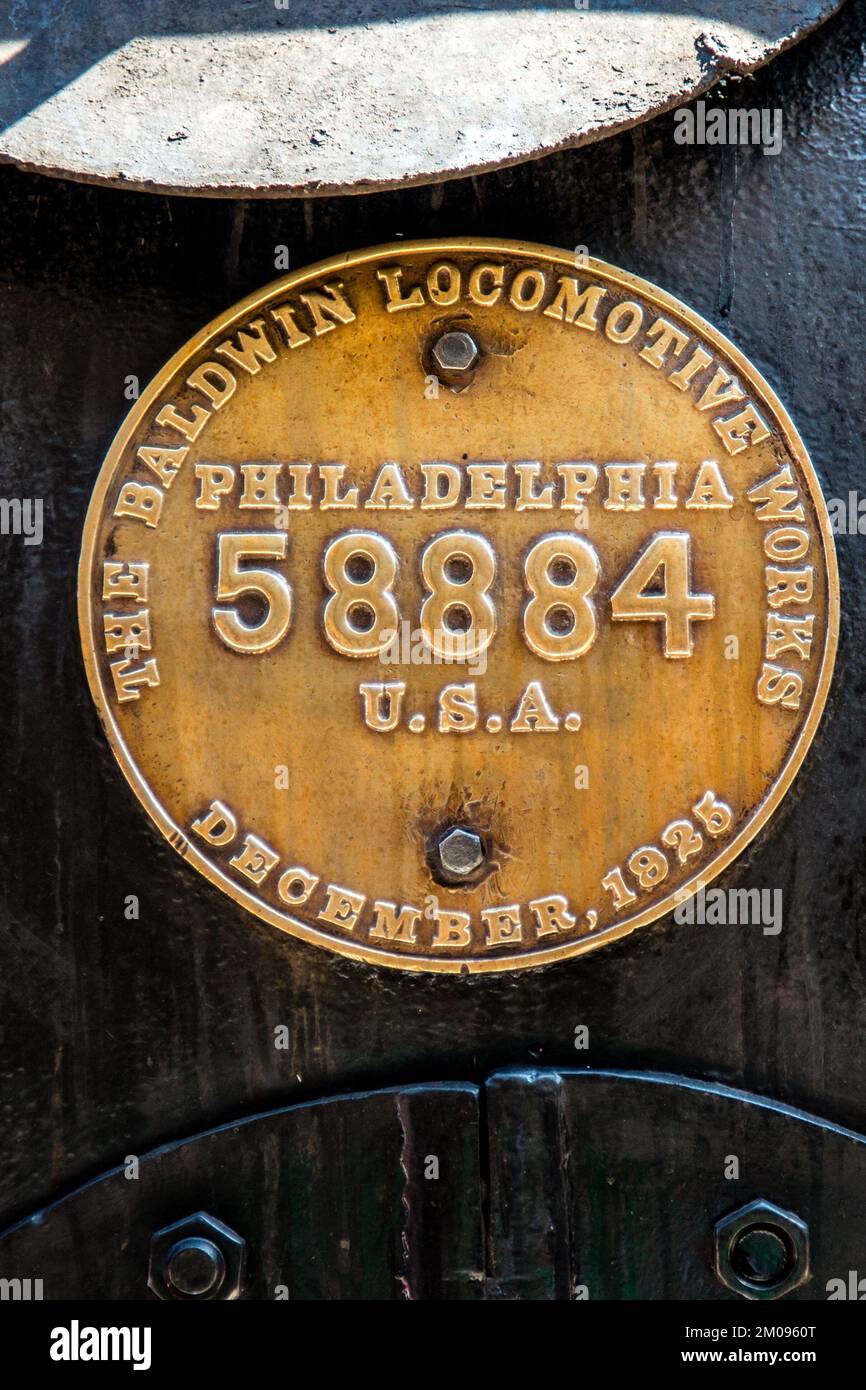 A closeup of a steam engine with a golden stamp with a writing "The ...