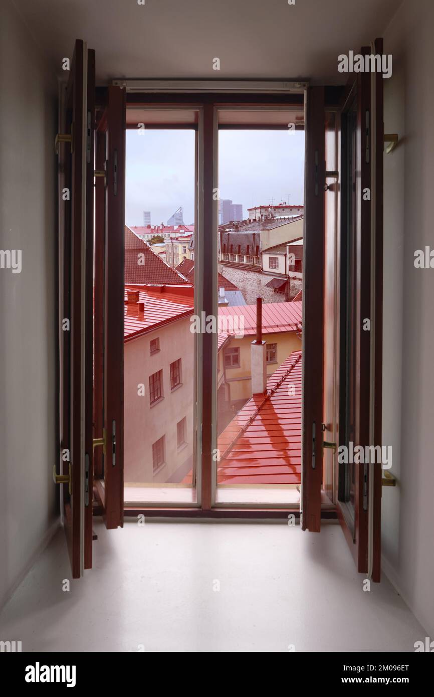 Old wooden window with view on roofs and towers in Tallin, Estonia ...
