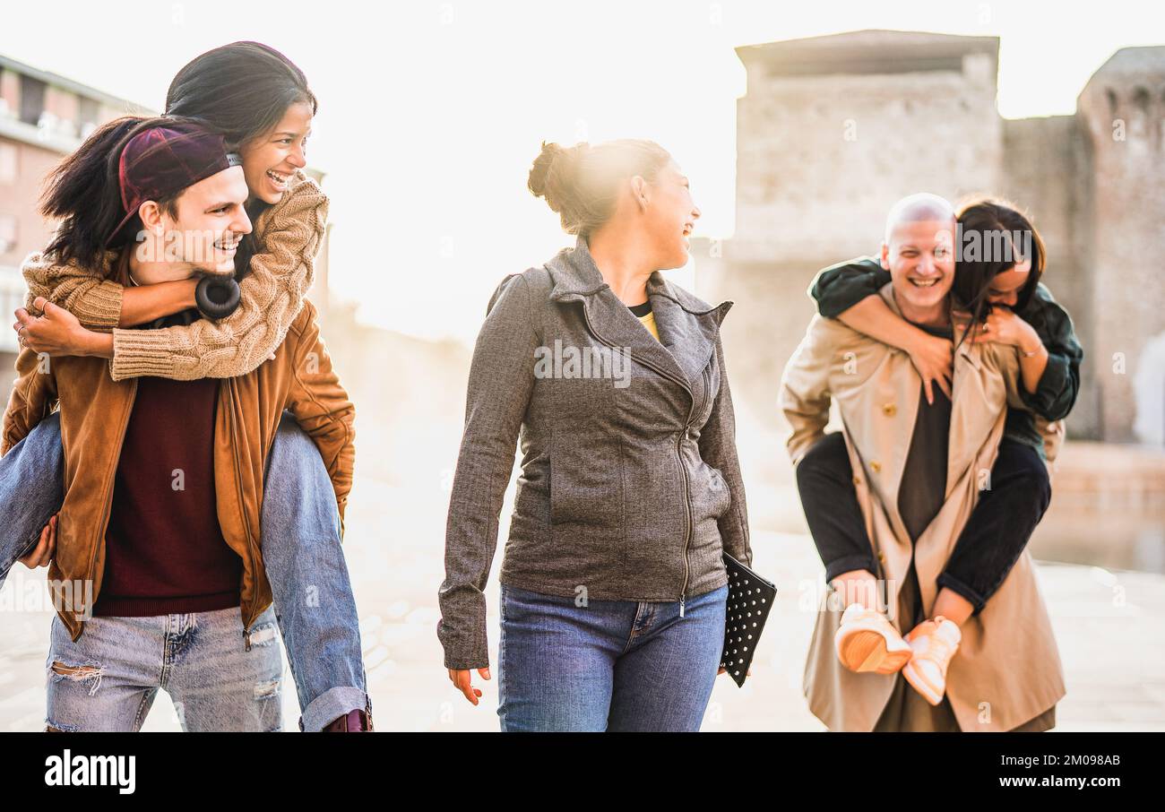 Genuine young people walking together on piggyback move - Life style ...