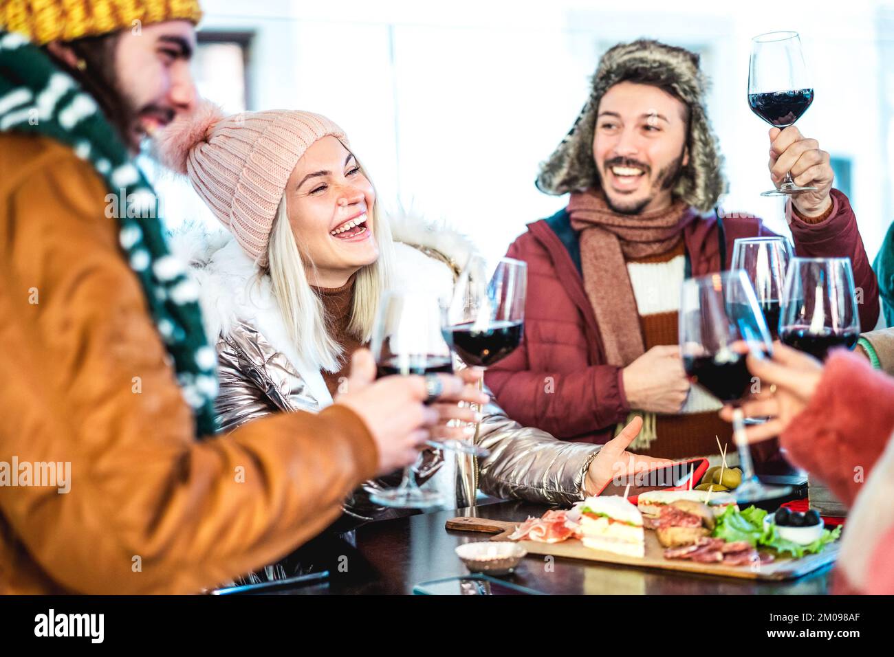 Young people toasting red wine at restaurant patio - Happy friends ...