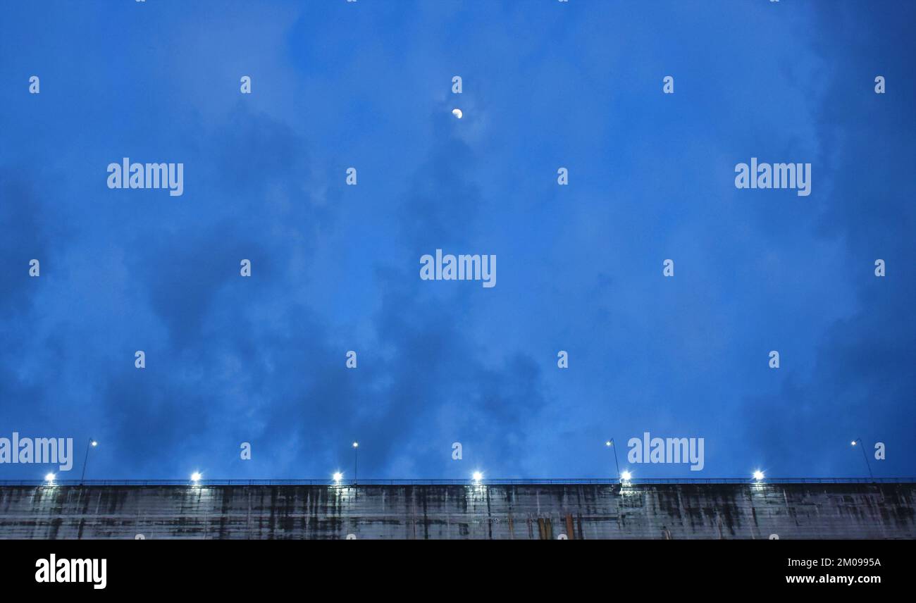 moon over Khun Dan Prakarn Chon huge concrete dam wall on night in ...