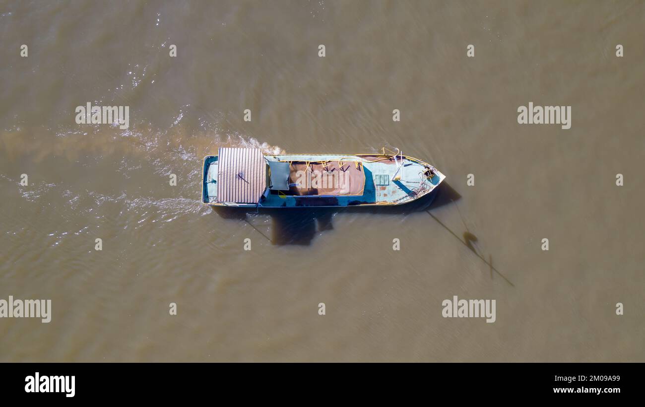 A top view of a dredge barge removing river sand on the surface of the ...