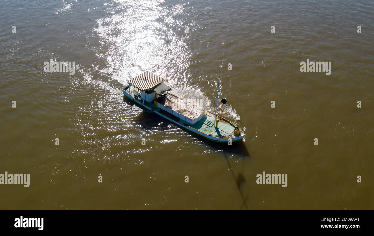 An aerial shot of a dredge barge removing river sand on the surface of the quiet sea Stock Photo ...