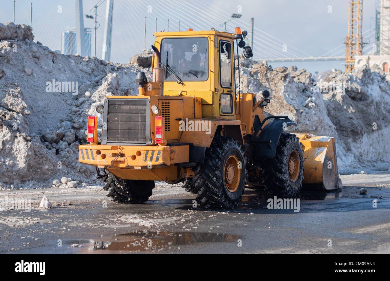 Removing snow after snowfall. Cleaning city street Stock Photo - Alamy