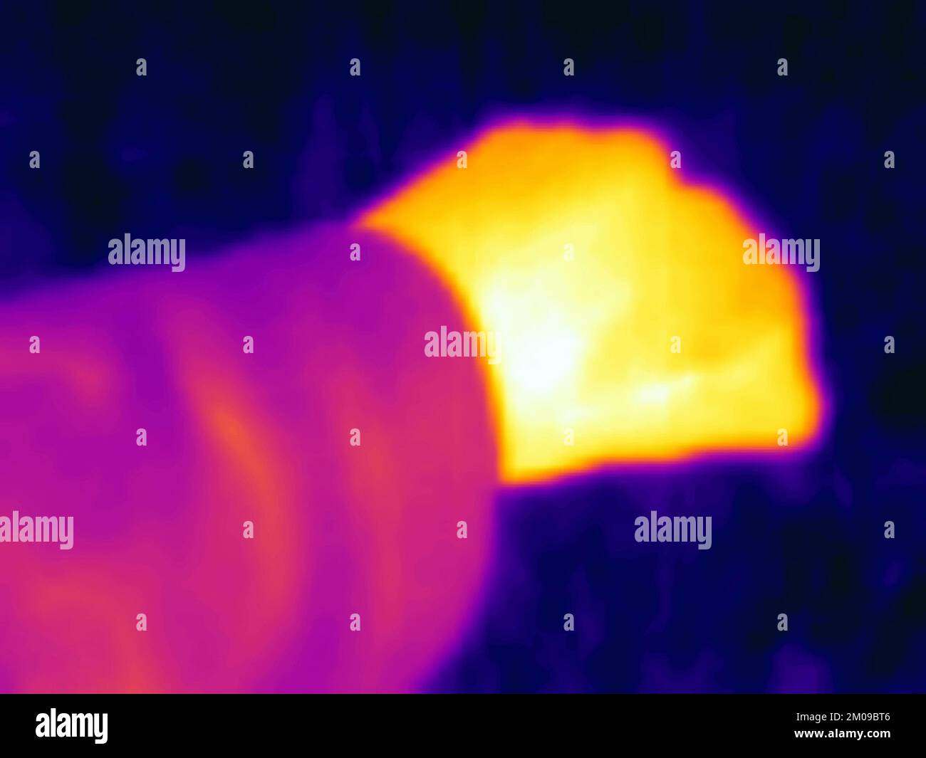 Fist strikes forward. Hand gestures captured on thermal imager. Warm ...