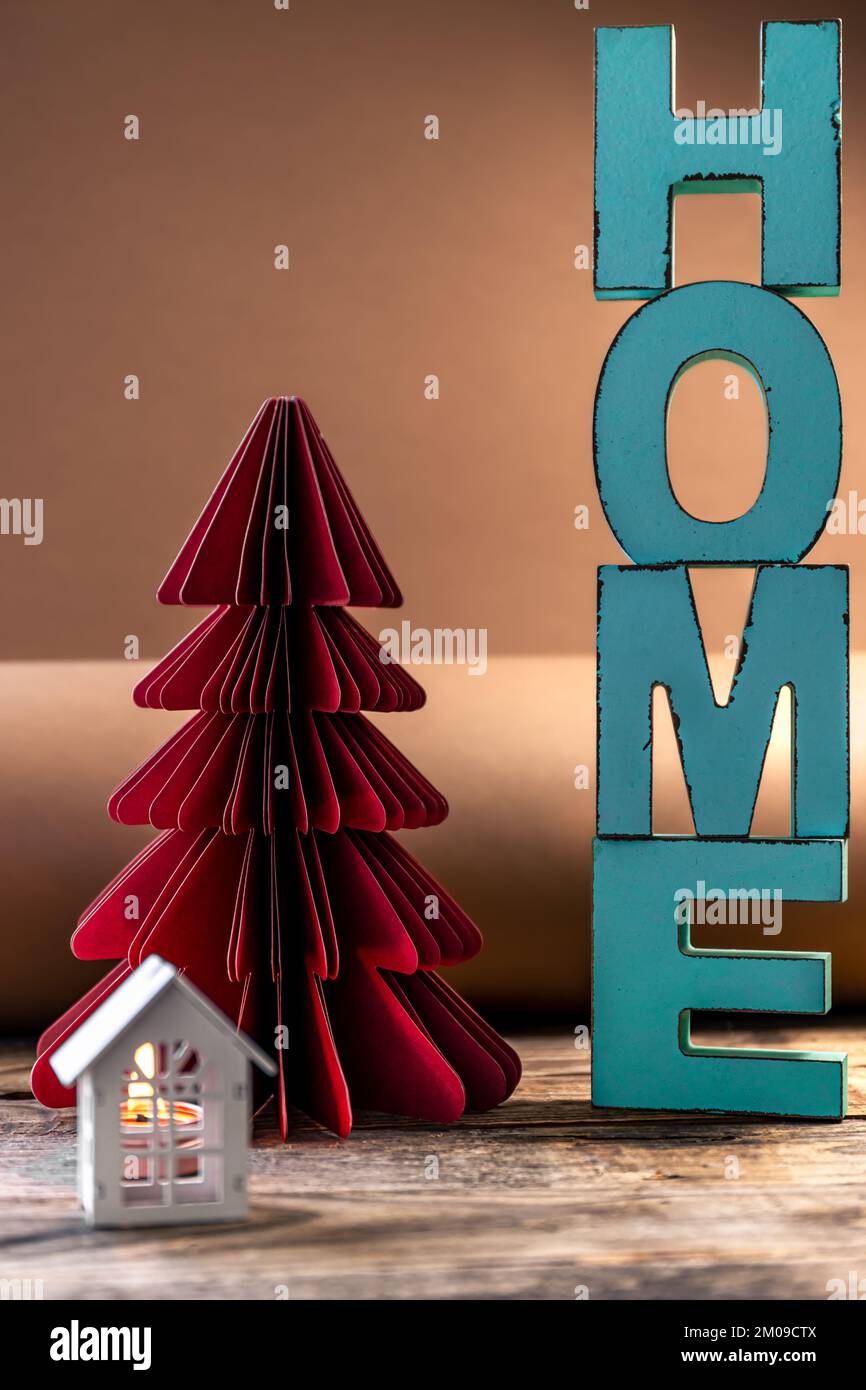 Cozy winter composition with decorative word home and paper christmas ...