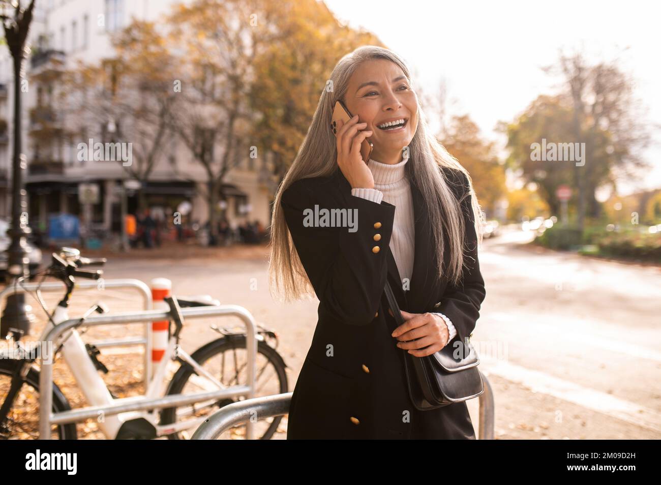 Smiling cute woman talking on the phone Stock Photo - Alamy
