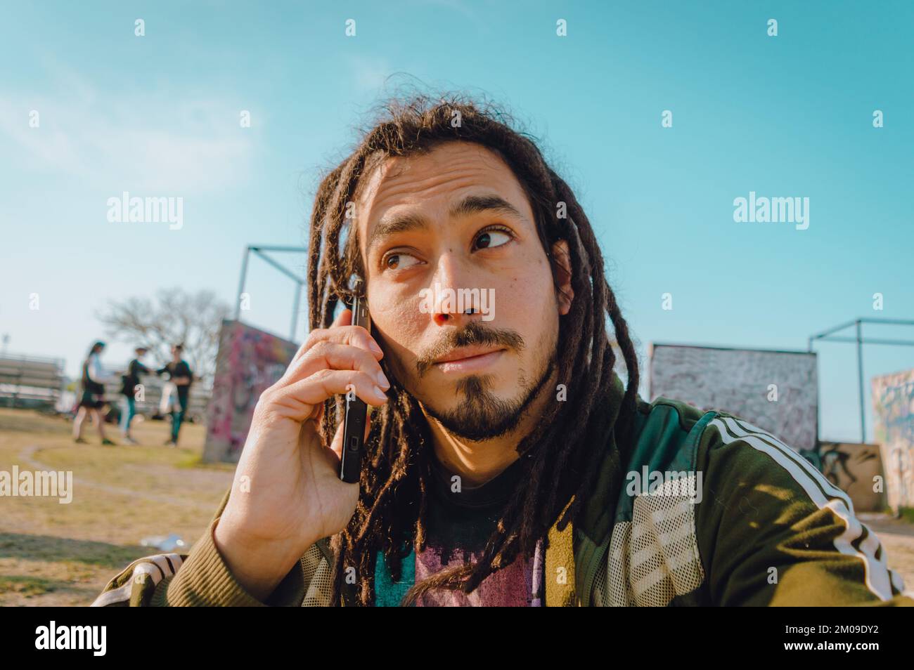 portrait of young caucasian venezuelan man with dreadlocks and beard ...