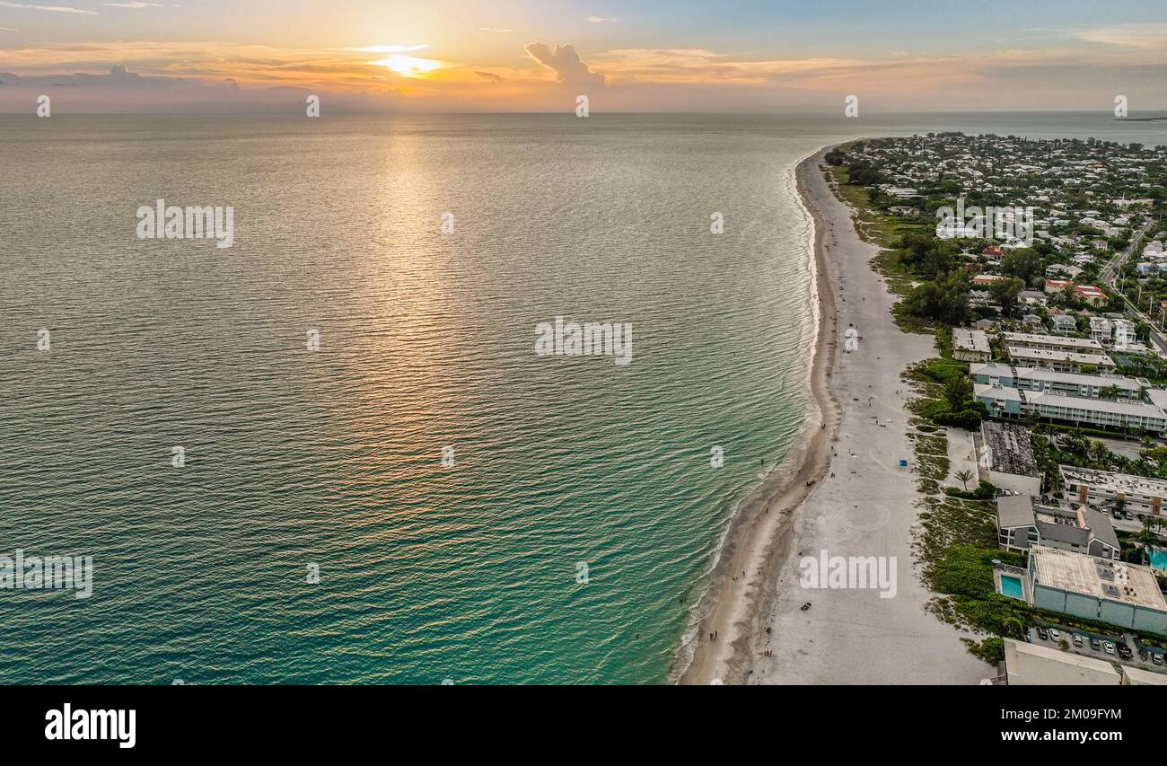 An aerial of Fort Myers beach with a cityscape view at sunset golden ...