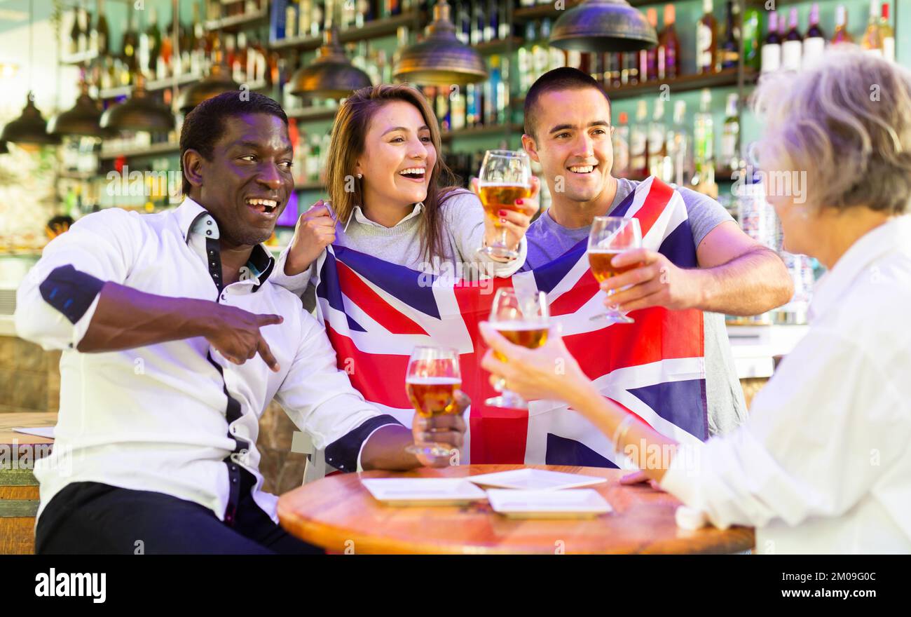 Emotional male and female drinking beer and celebrating success of ...