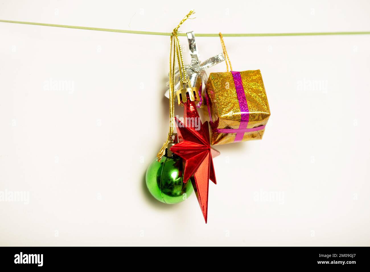 Christmas gifts are hanging on isolated white background Stock Photo ...