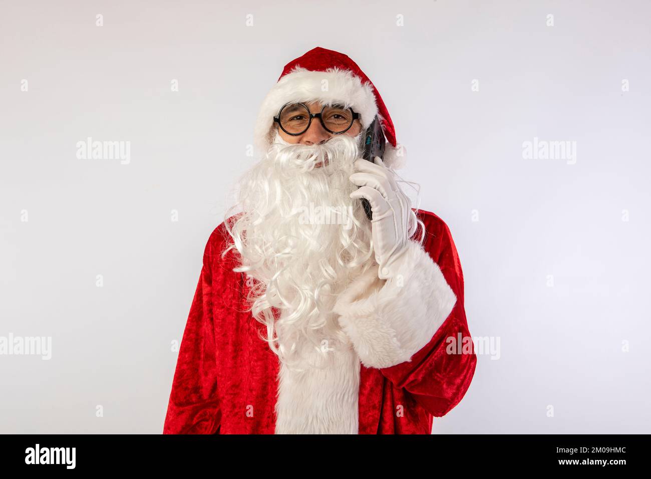 model of santa claus talking and using the mobile phone on a white ...