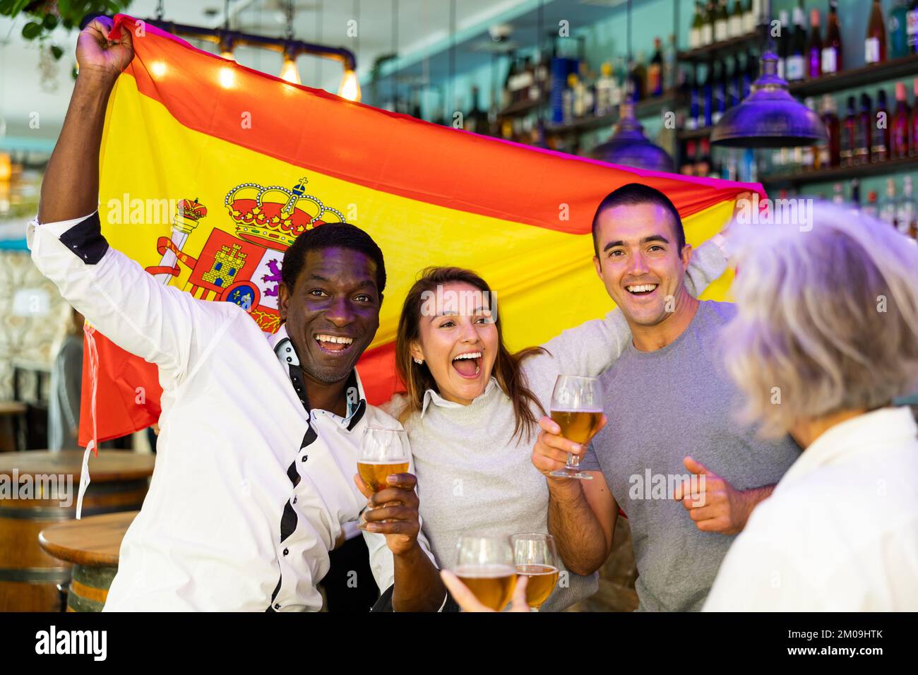 Cheerful international sport football fans waving Spanish flag and ...