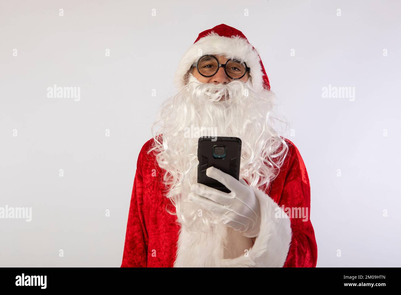 model of santa claus talking and using the mobile phone on a white ...