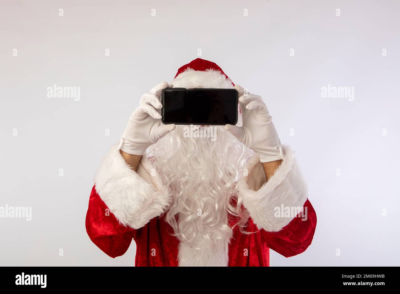 model of santa claus talking and using the mobile phone on a white ...