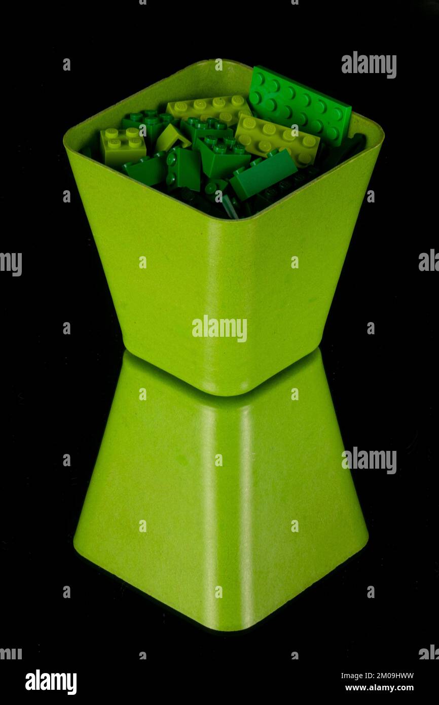 Green bucket full of green Lego blocks on a reflective surface Stock ...