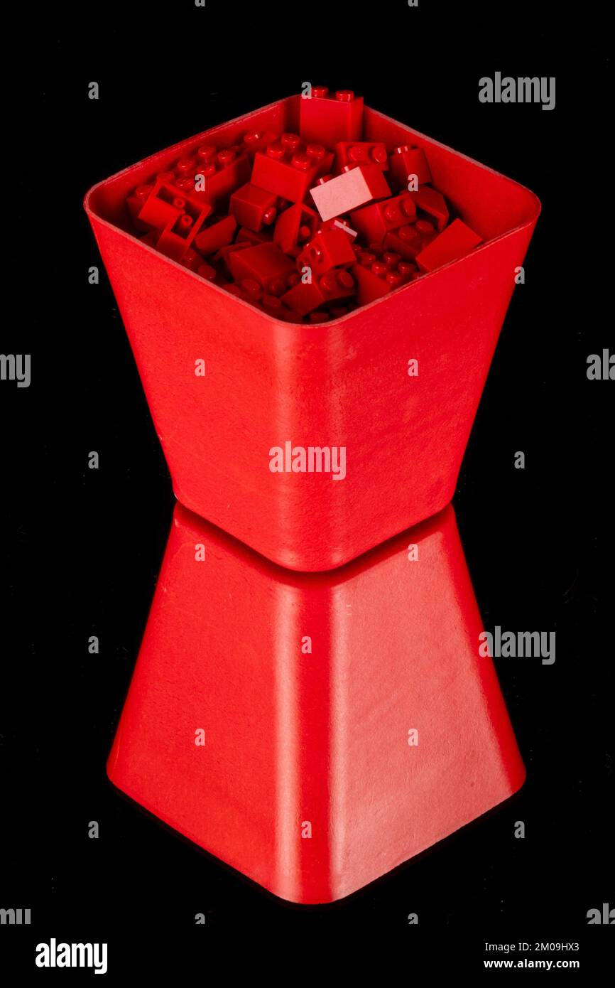 Red bucket full of red Lego blocks on a reflective surface Stock Photo ...