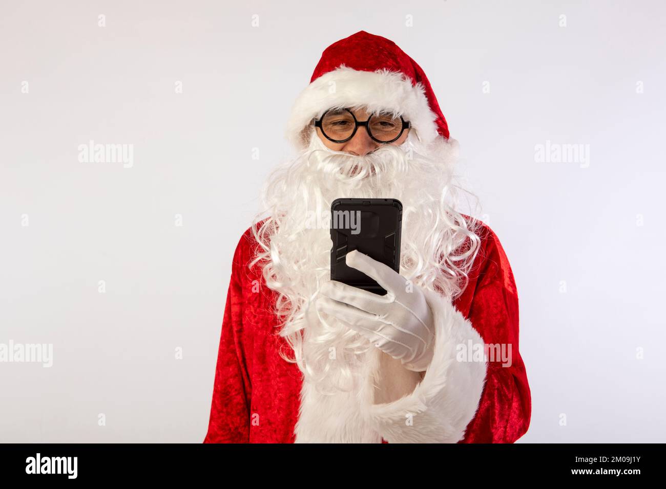 model of santa claus talking and using the mobile phone on a white ...