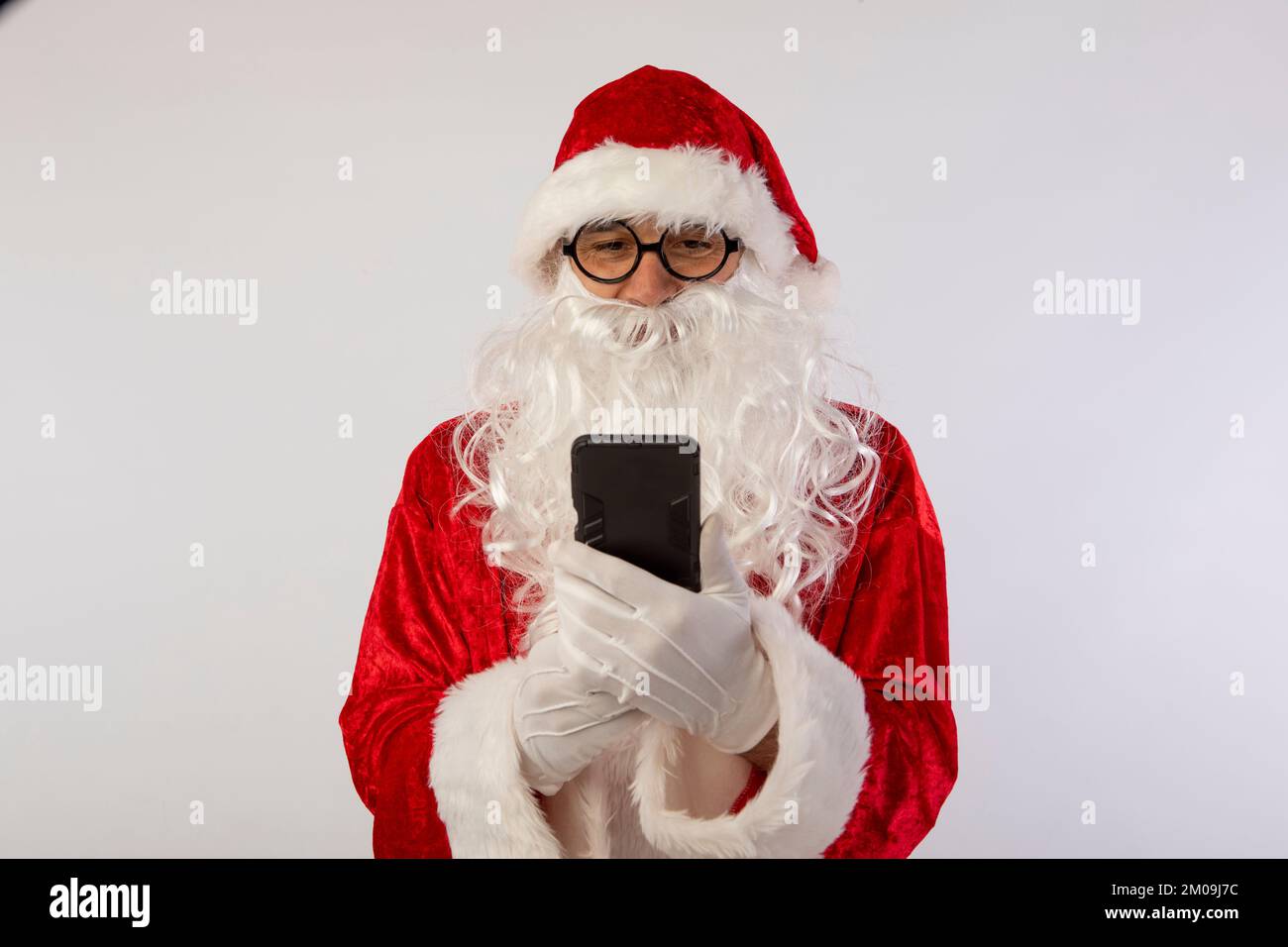 model of santa claus talking and using the mobile phone on a white ...
