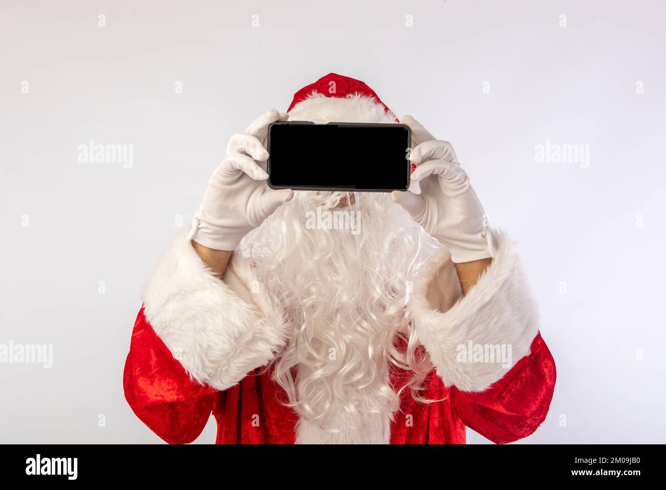 model of santa claus talking and using the mobile phone on a white ...