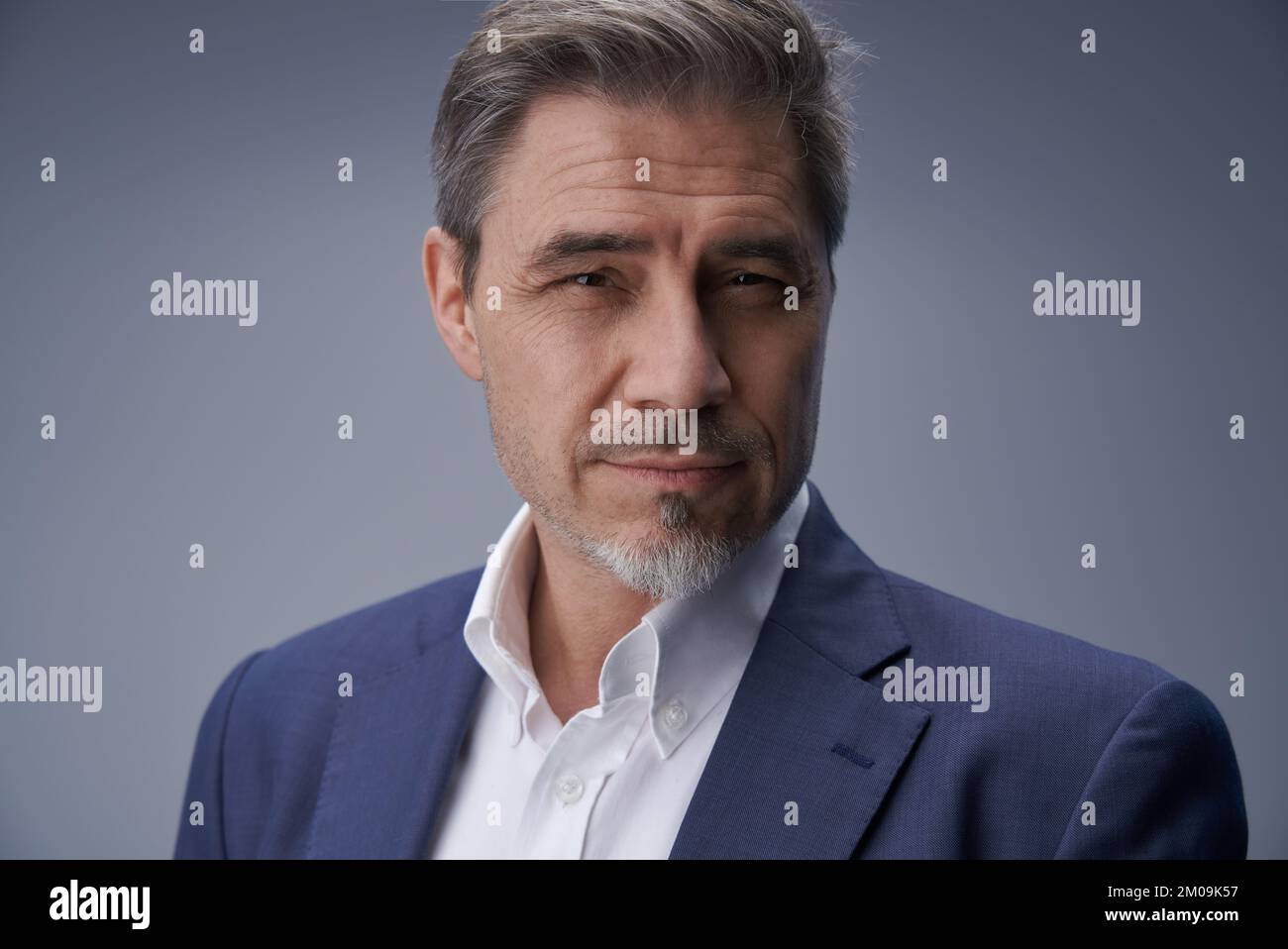 Business portrait - businessman smiling, jacket and open collar white ...