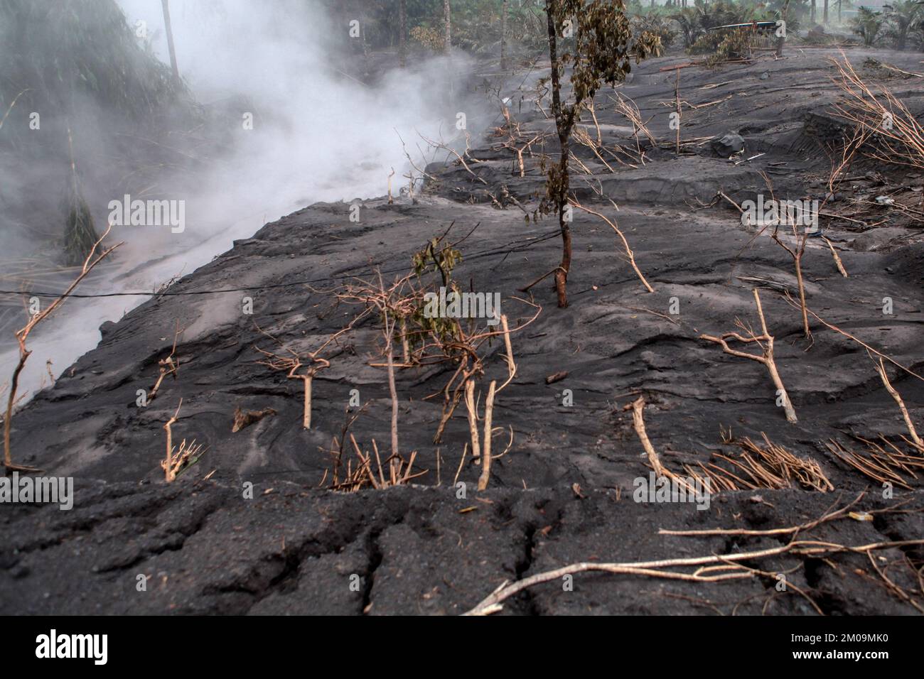 Lumajang, Indonesia. 5th Dec, 2022. Smokes and volcanic materials are ...