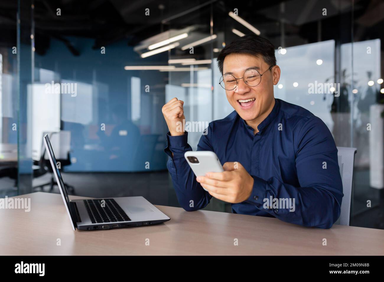 Successful asian businessman celebrating victory and happy good news ...