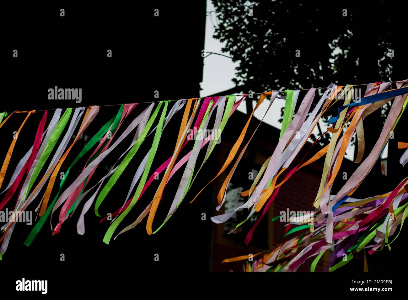 ribbon garlands outdoor. colored textile ribbons Stock Photo - Alamy