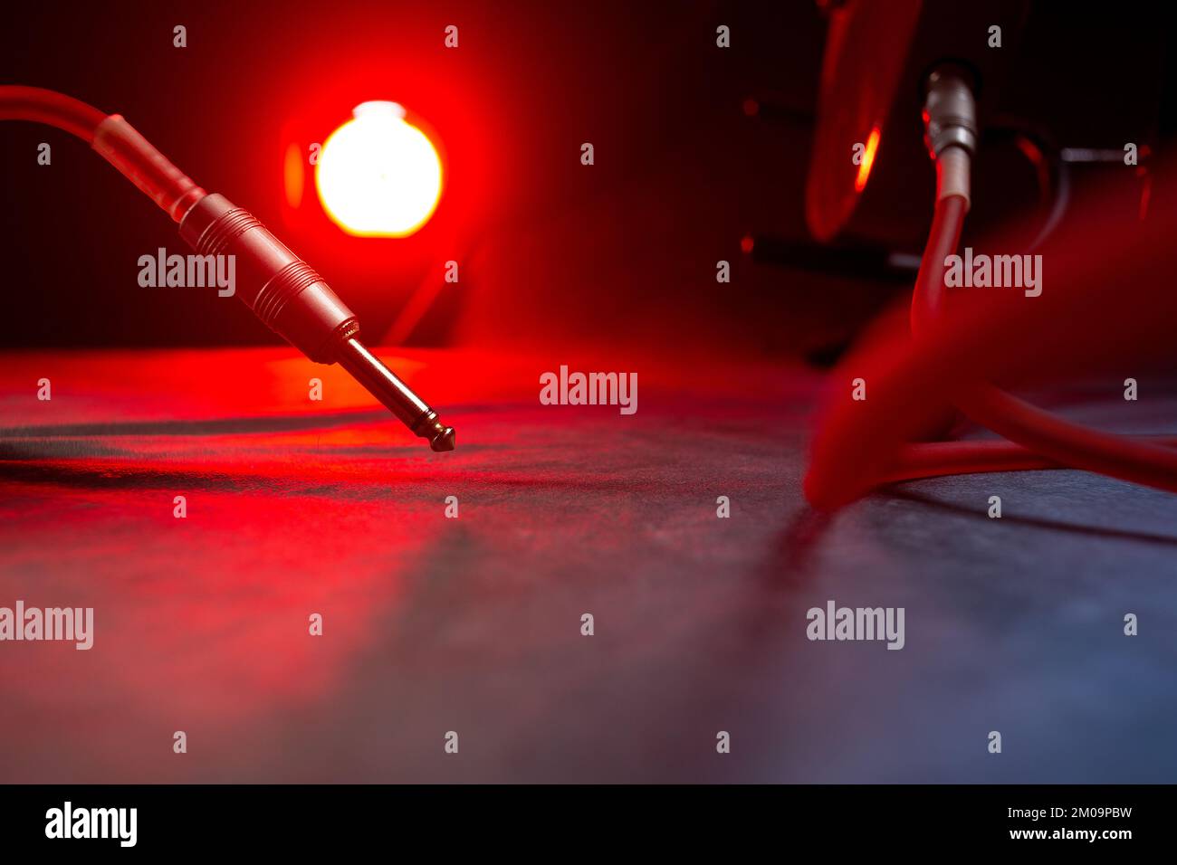 guitar pulled from the ground on the stage and the jack cable connected ...