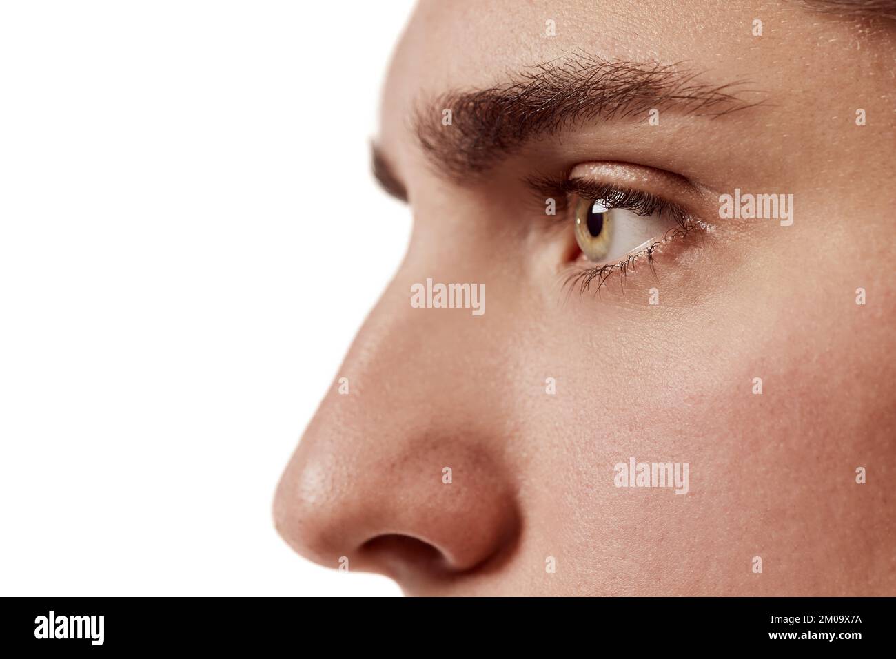 Side view portrait of young man isolated over white background. Nose ...