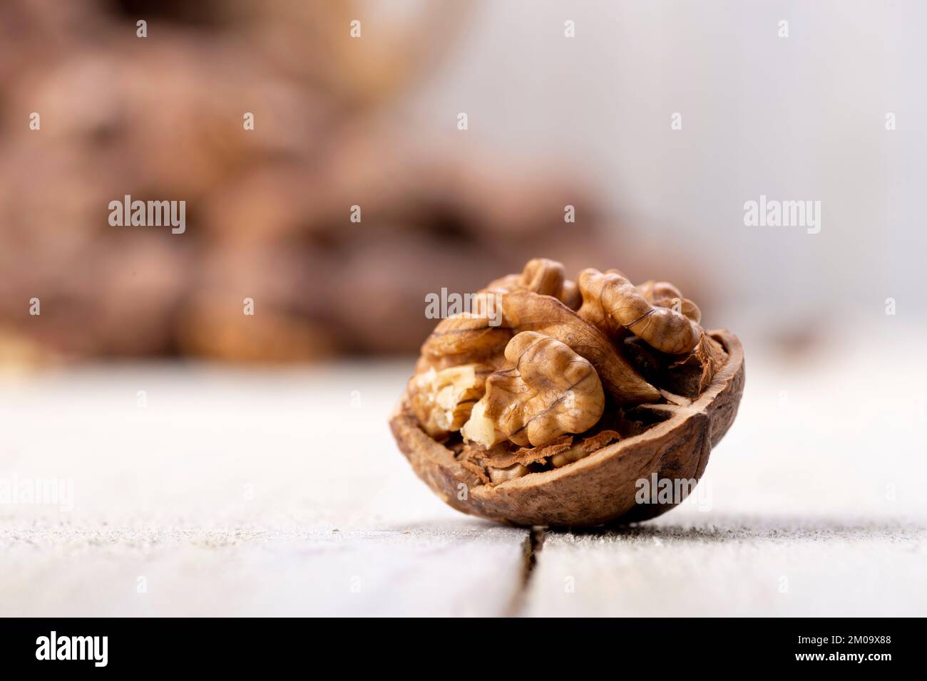 Stacked walnuts from basket on white wooden table - walnut harvest ...