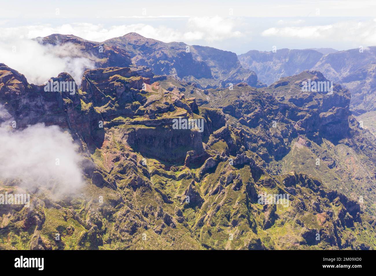 Drone view of mountain peak submerged in fog during summer day Stock ...