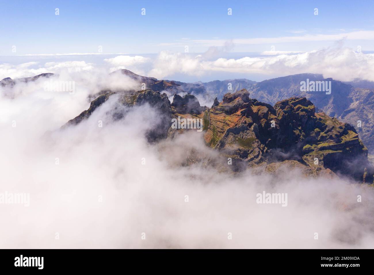 Drone view of mountain peak submerged in fog during summer day Stock ...