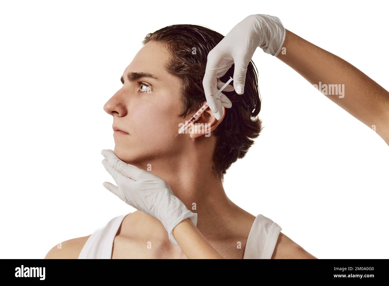 Portrait of young man and female hands in gloves making injections in ...