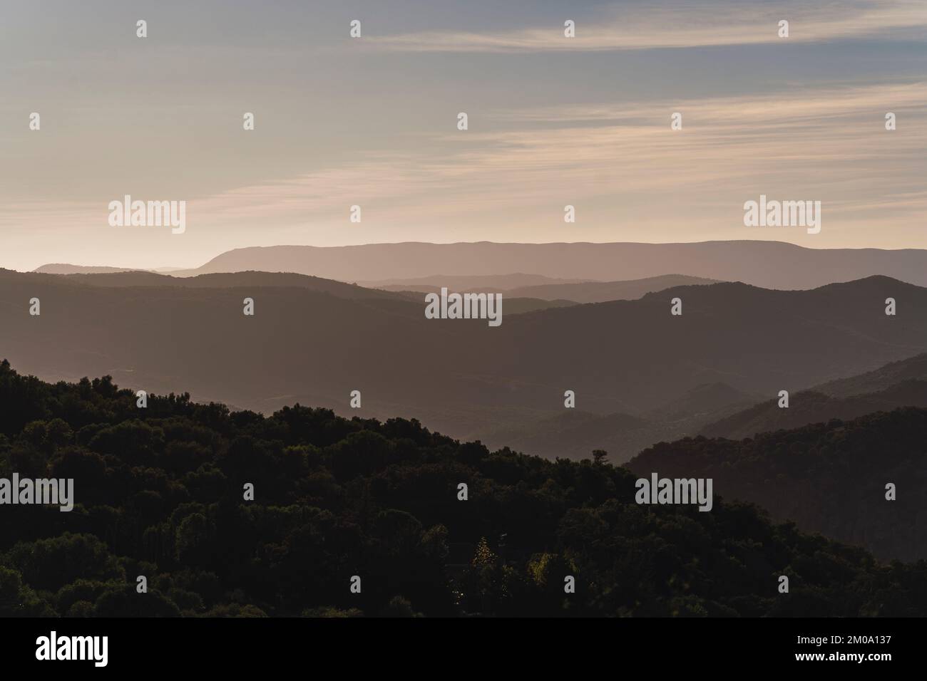 An aerial view of beautiful mountain silhouettes under a bright sunny ...