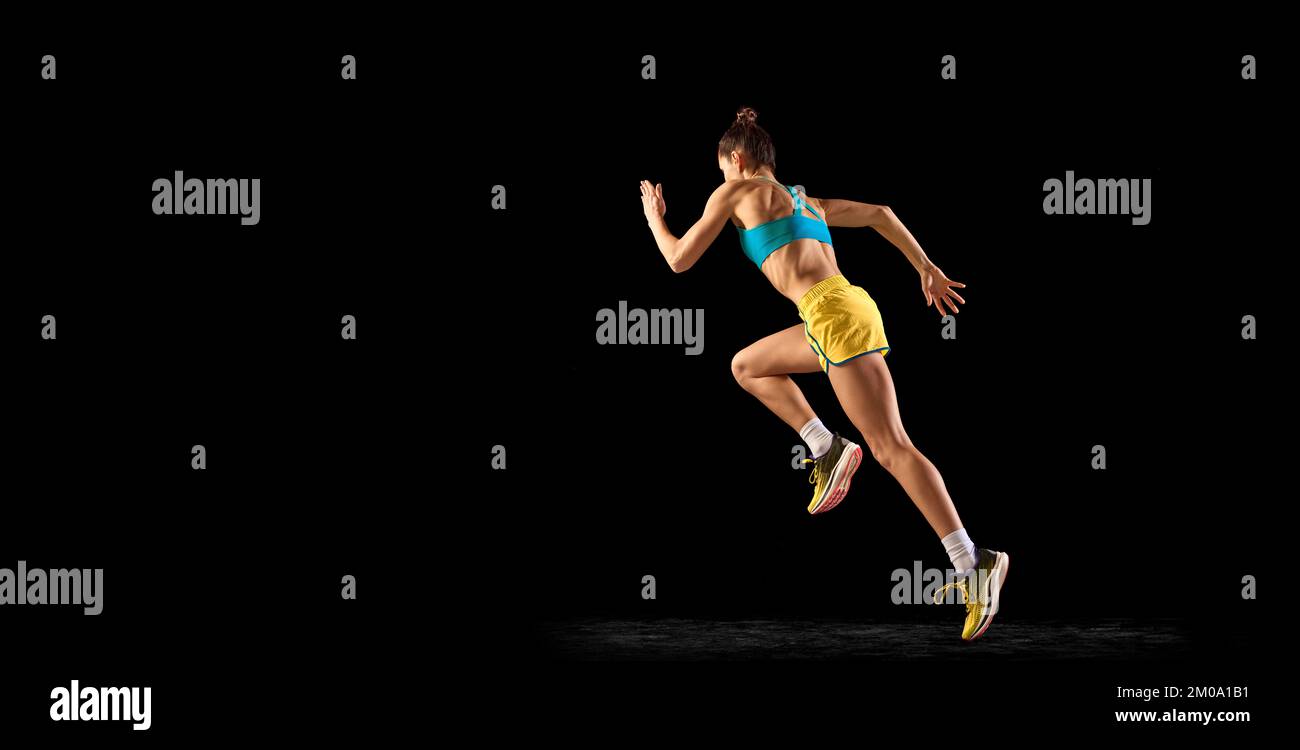 Female athlete in action. Young fitness sportive girl in sports uniform ...