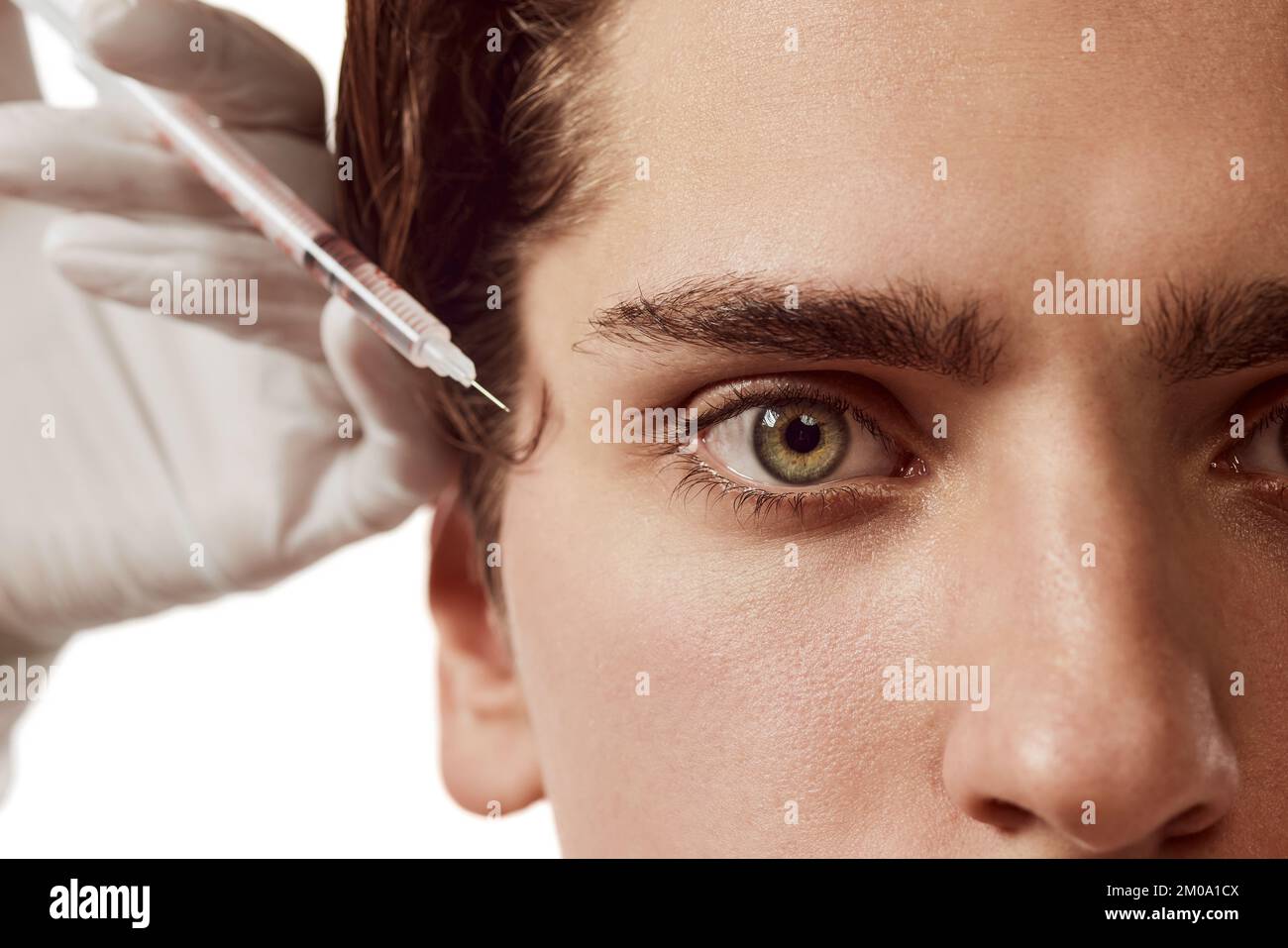 Portrait of young man, males and cosmetologist hands making eye anti ...