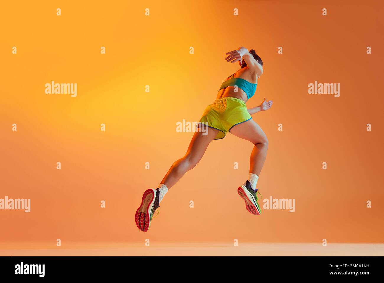 Back view. Sportive muscled woman, professional runner running away ...