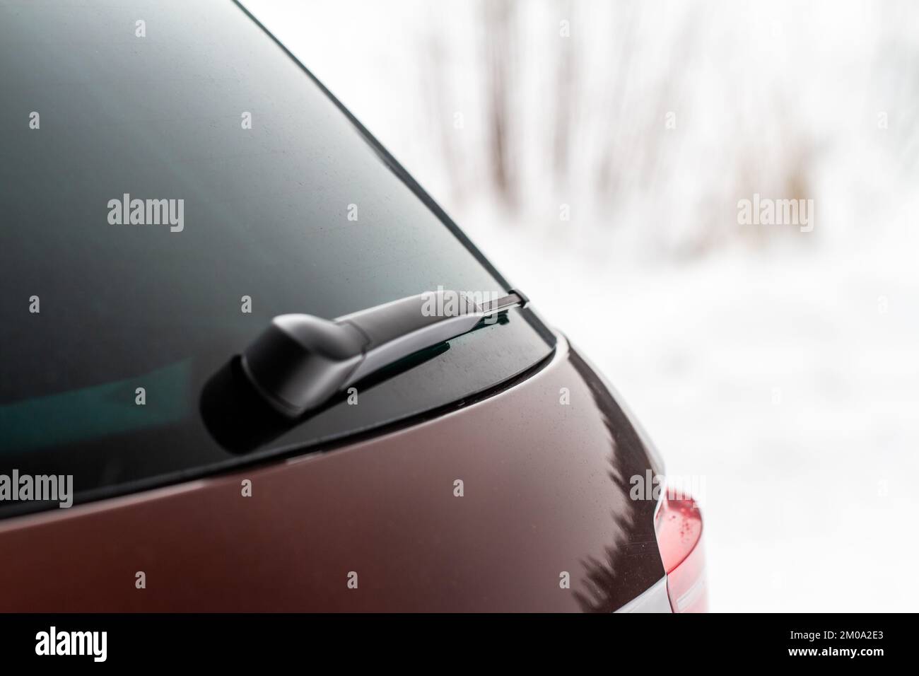 Winter back car window. A car wiper cleans the rear window Stock Photo ...