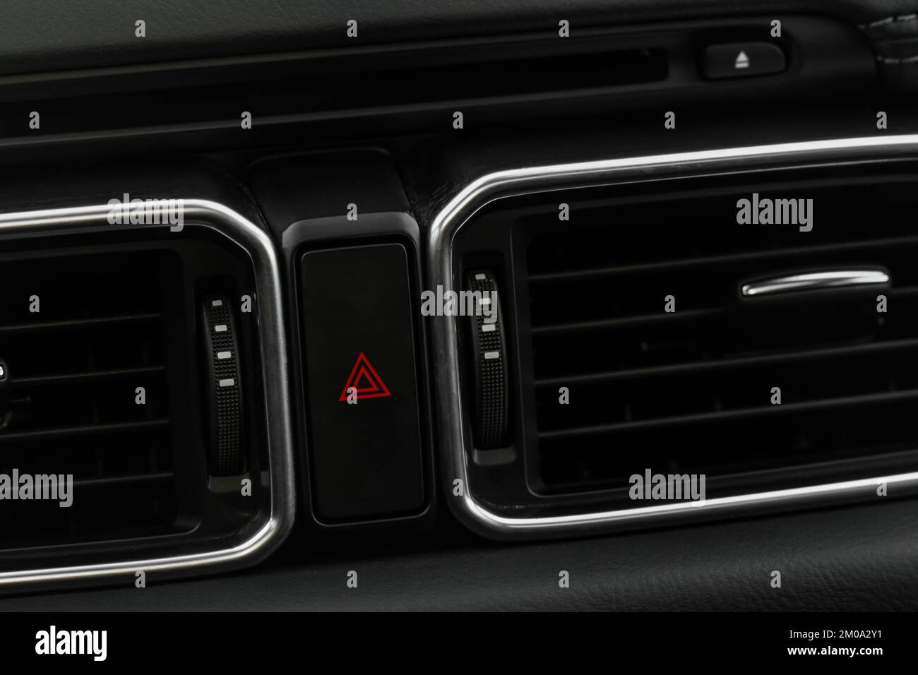 Red triangle hazard light button on car dashboard. Car media buttons ...