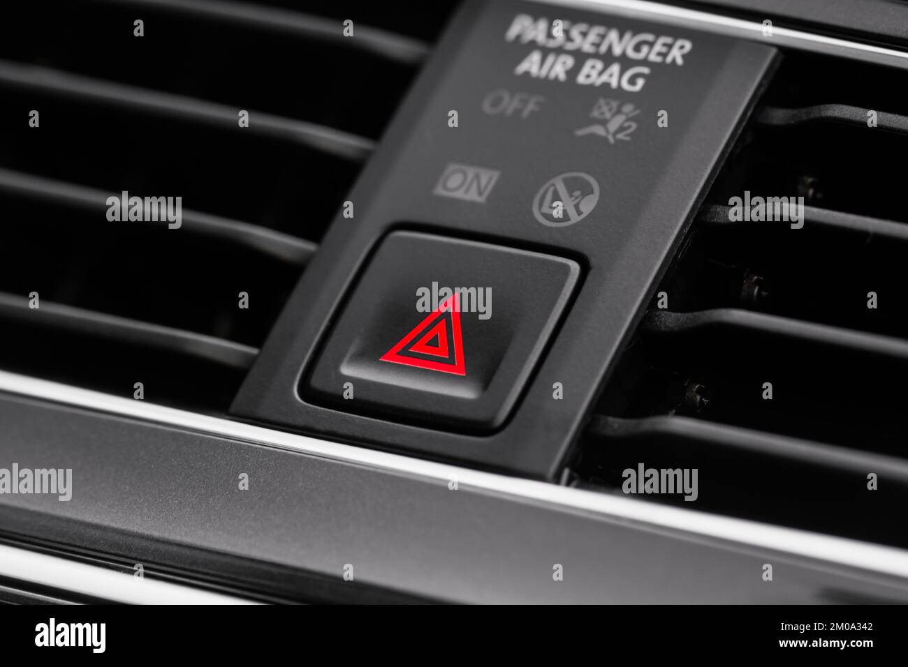 Red triangle hazard light button on car dashboard. Car media buttons ...