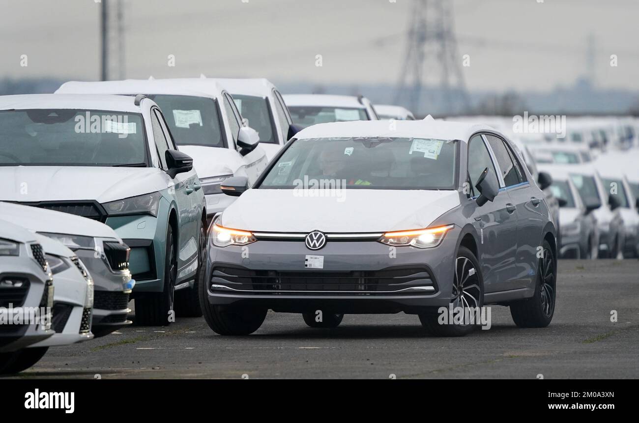 New cars are manoeuvred around a dockside compound in Sheerness, Kent ...
