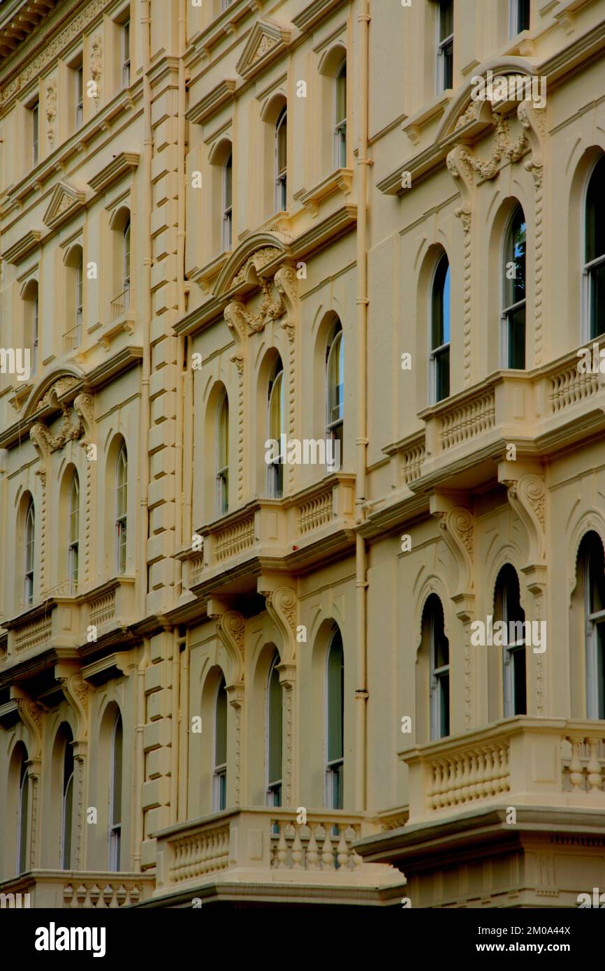 A vertical shot of an exterior view of an old building with sculptures ...