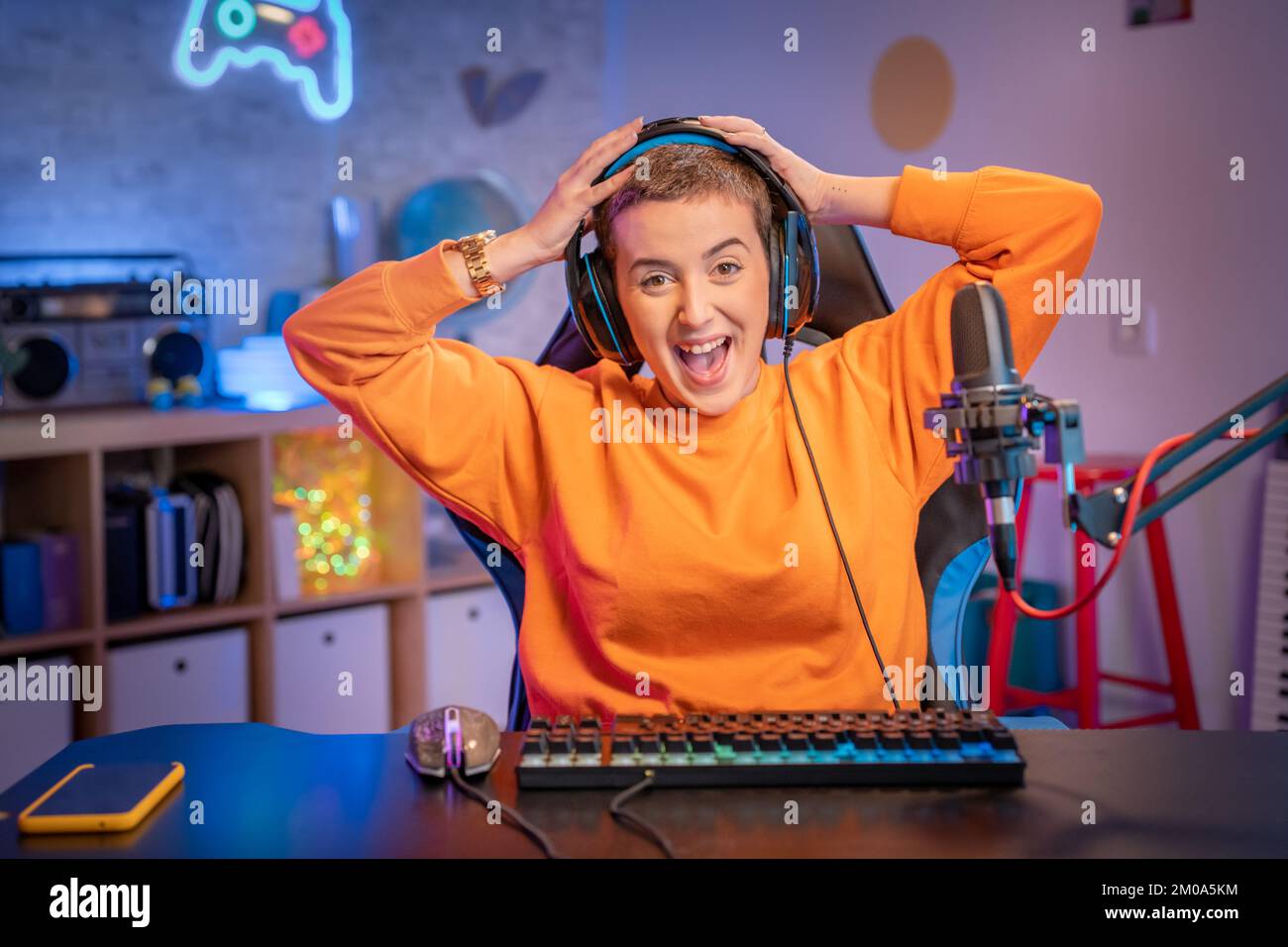 Excited Gamer Girl in Headset with a Mic Playing Online Video Game on ...