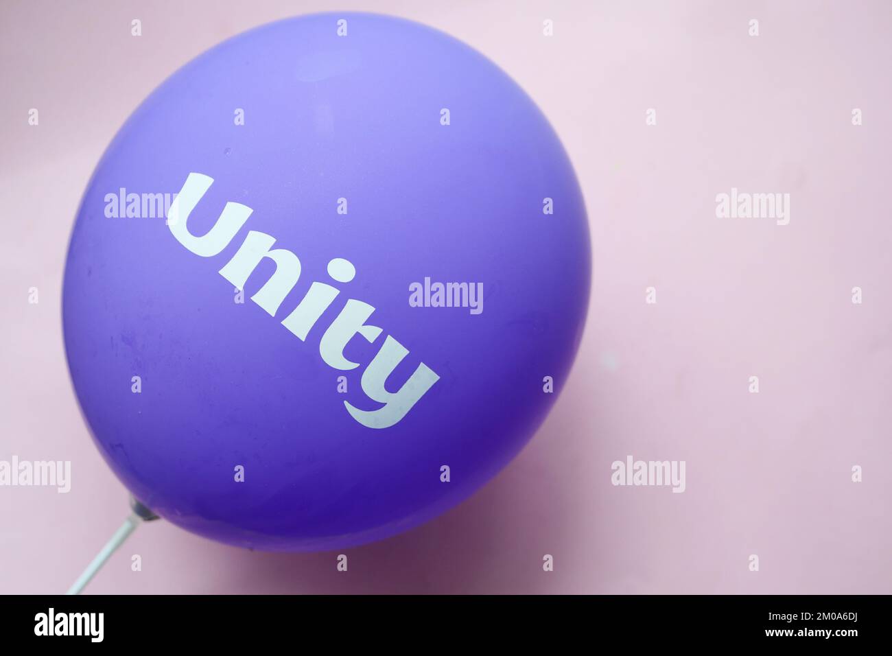 unity text on a purple color ballon Stock Photo - Alamy
