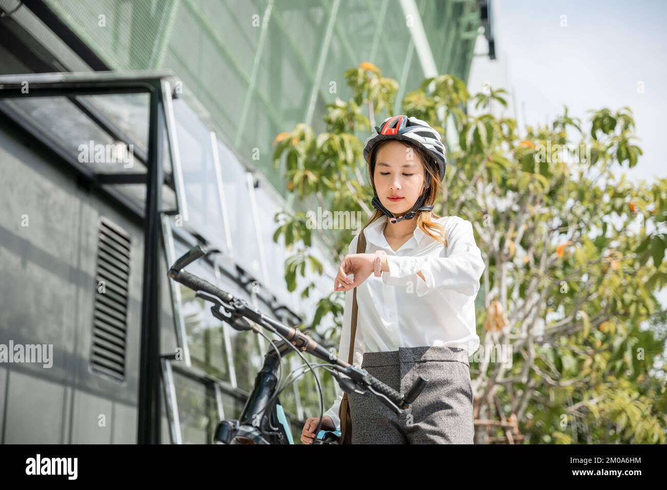 Portrait smiling woman check watch Stock Photo - Alamy