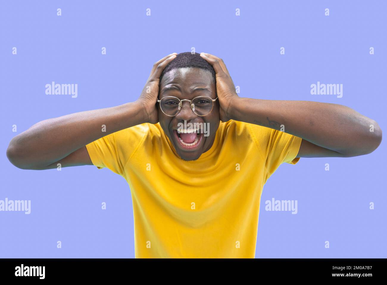 Handsome African American man with hands in head excited and scared ...